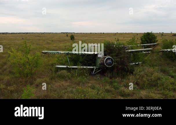 Drone shot of weathered An-2 Antonov biplane abandoned in old airfield ...