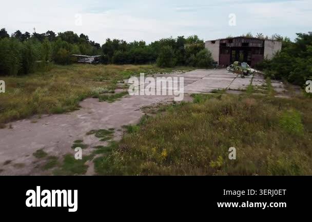 Aerial view of abandoned airbase with retired airplanes, old helicopter ...