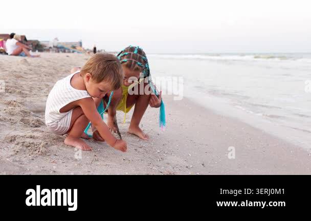 Kind skinny cute older sister plays with her little brother toddler ...