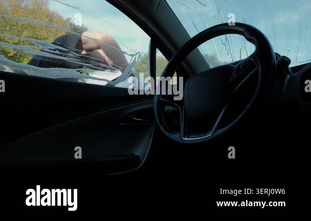 Shot from inside a parked car showing the driver-side interior in the ...