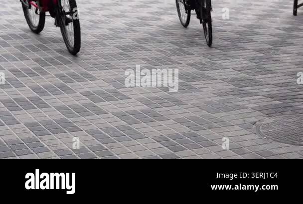 City cycling on paving slabs on a bright day Stock Video Footage - Alamy