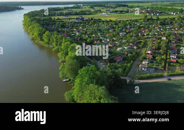 Aerial View of Waterfront Landscape with Trees, Fields and Buildings on ...