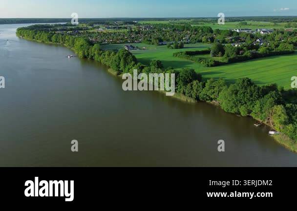 Aerial View of Waterfront Landscape with Trees, Fields and Buildings on ...