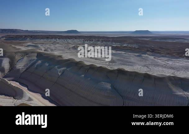 Cinematic aerial flight over the expansive and dry Kyzylkup tiramisu ...
