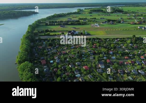 Aerial View of Waterfront Landscape with Trees, Fields and Buildings on ...