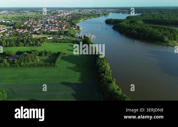 Aerial View of Waterfront Landscape with Trees, Fields and Buildings on ...
