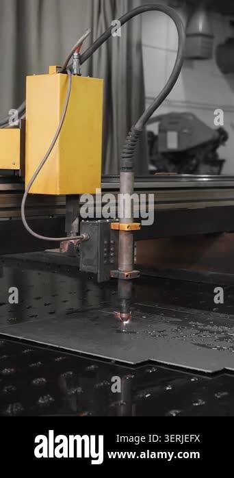 Close up of automated CNC plasma cutting machine processing steel sheet ...