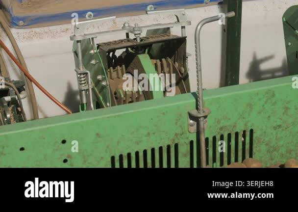 Close up of potato planting machine mechanism transporting seed ...