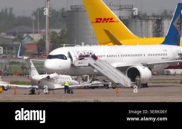 ALMATY, KAZAKHSTAN - MAY 10, 2024: Passengers board an Air Astana ...