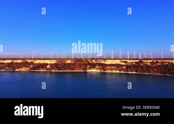 Wind turbines above limestone sea cliffs at the Black Sea, Bulgaria ...