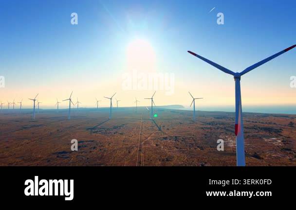 Wind farm turbines at sunset over coastal steppe, Bulgaria. Drone ...
