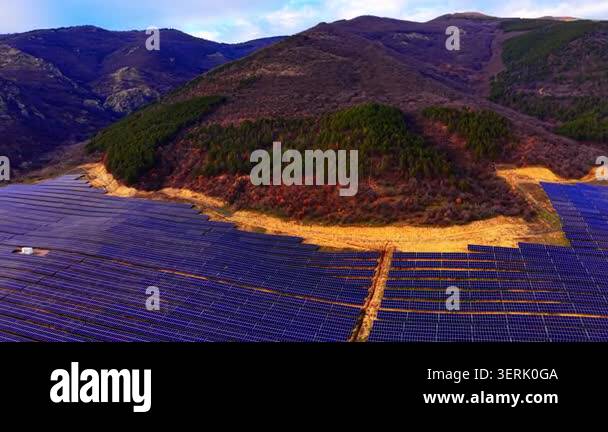 Sunset light over solar farm and rolling plains, Bulgaria. Drone ...