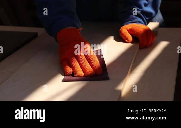 Manual sanding of a wooden surface with sandpaper. A craftsman in ...