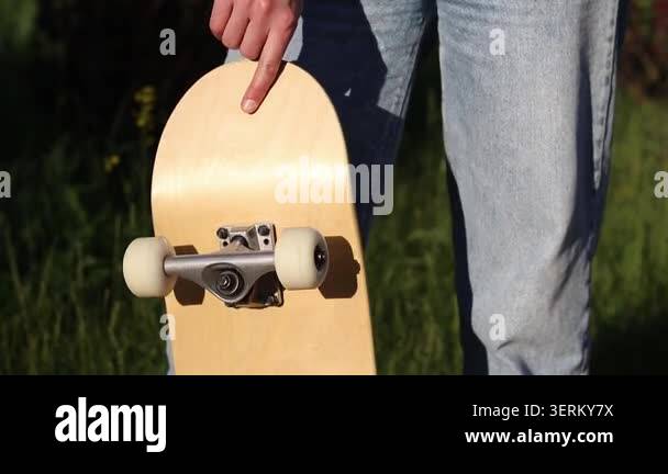 Young girl with wooden skateboard outdoors. Skater holding board while ...