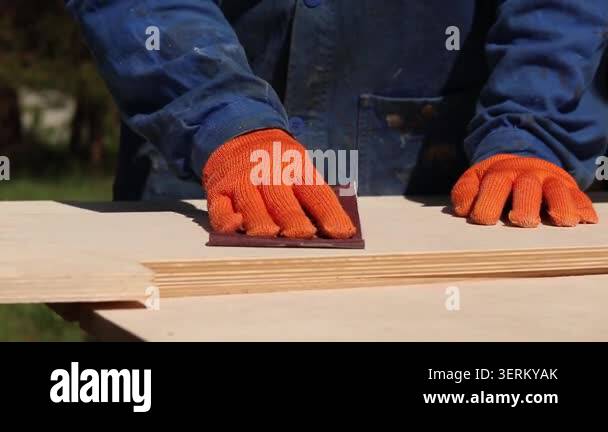 Manual sanding of a wooden surface with sandpaper. A craftsman in ...