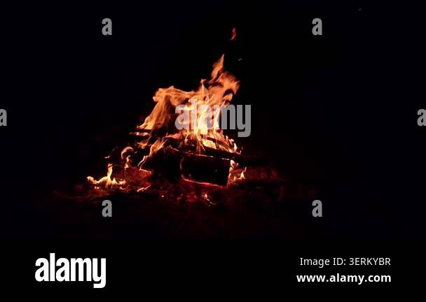 Bonfire at night on a dark background. Bright flame of a bonfire ...
