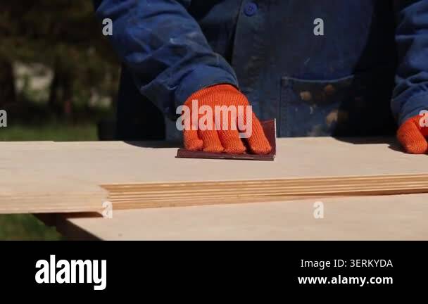 Manual sanding of a wooden surface with sandpaper. A craftsman in ...