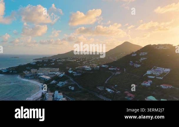 Aerial view of the resort coastline and lush green hills on the island ...