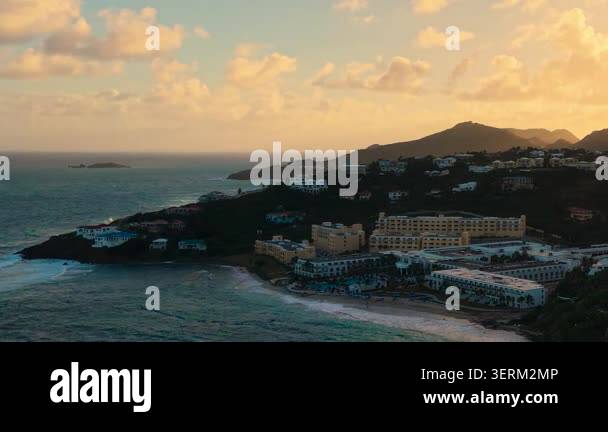 Aerial view of the resort coastline and lush green hills on the island ...
