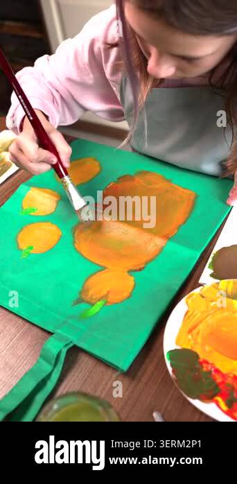 Top angle view of generation alpha girl painting eco friendly green ...