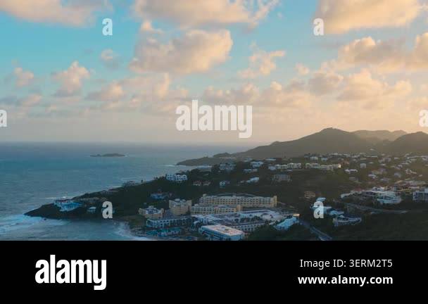 Aerial view of the resort coastline and lush green hills on the island ...