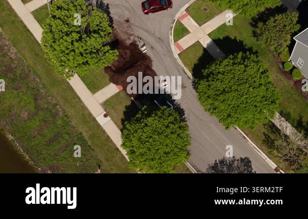 Drone top down footage of Skid steer loader transporting fresh mulch ...