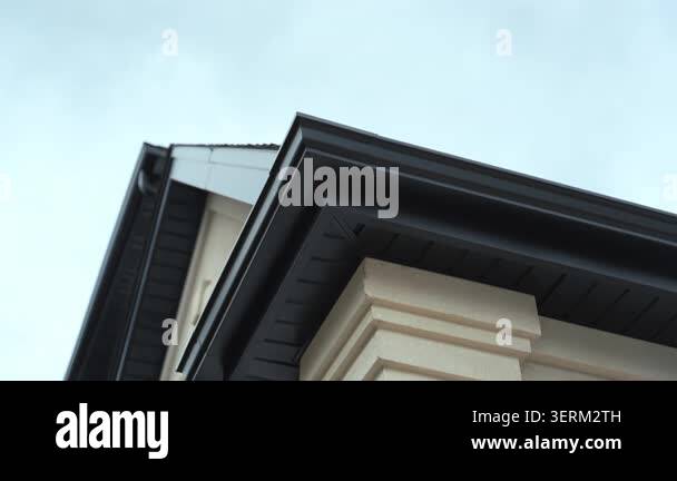 Element of residential house exterior with corner of new roof. High ...