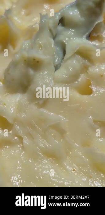 Close-up macro view of thick cream hair mask texture being swatched and ...