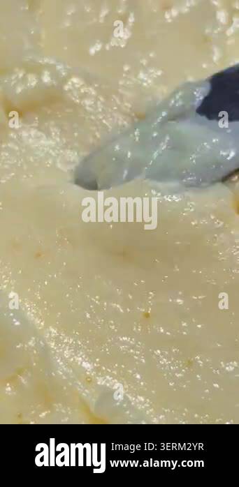 Close-up macro view of thick cream hair mask texture being swatched and ...