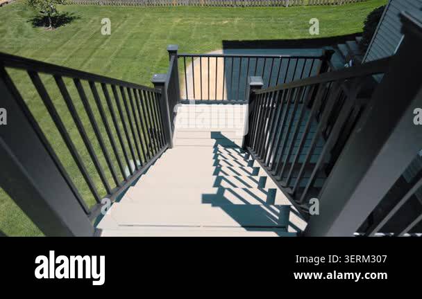 Modern elevated backyard deck attached to house featuring black metal ...