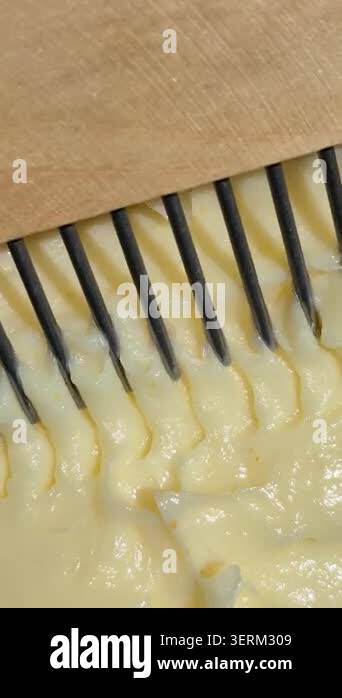 Close-up macro view of thick cream hair mask texture being swatched and ...