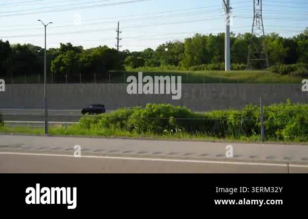 Side POV driving on a busy multi lane highway with moving traffic ...