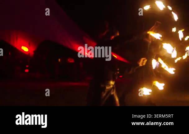 Sigulda, Latvia - June 11, 2026: Fire performer skillfully twirls ...