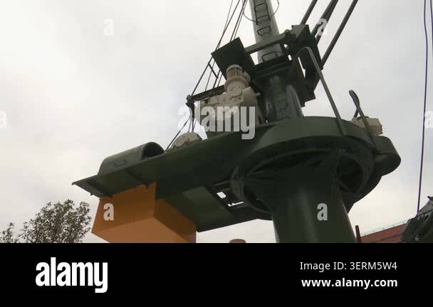 Low-angle view of the rotating mechanism and cabin of a vintage green ...