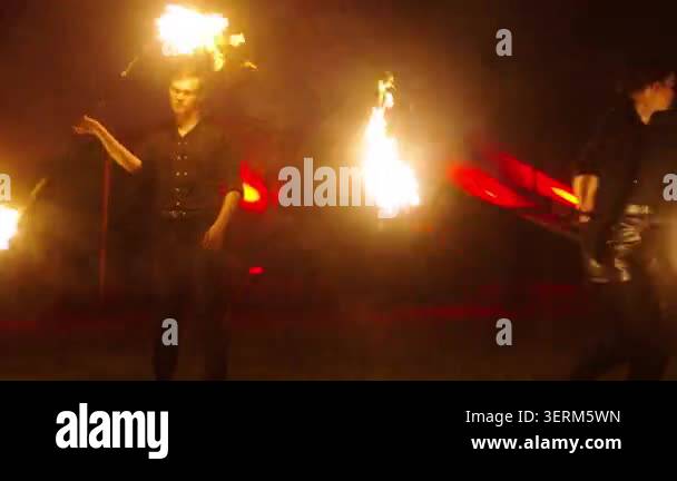 Sigulda, Latvia - June 11, 2026: Fire performers in black attire ...