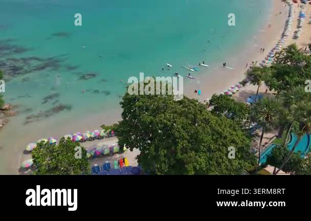 Aerial perspective captures beachgoers engaging in water activities ...