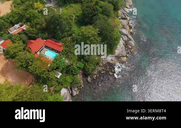 Aerial perspective of a tropical coastal property featuring a swimming ...