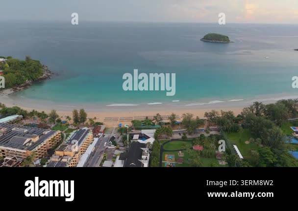 Aerial perspective of a serene tropical beach with soft waves lapping ...