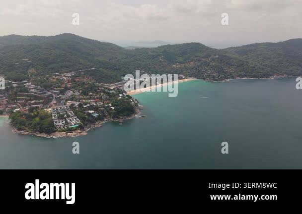 Aerial perspective of a coastal area featuring a sandy beach, lush ...