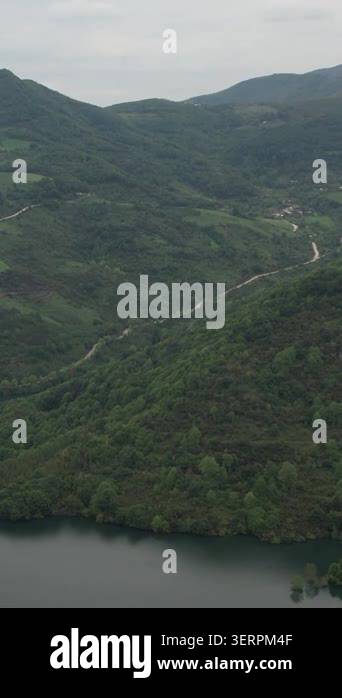 Overhead view of hills and mountains with forest beside the lake, the ...