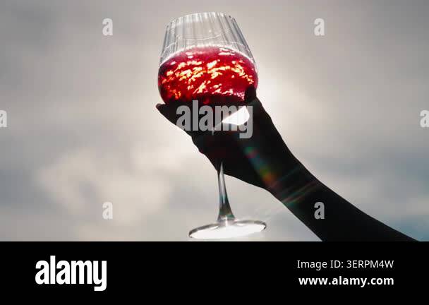 Romantic Red Wine Moment Framed by Sunlight and Dreamy Sky Background ...