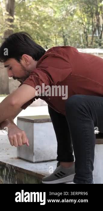 Back view of Muslim bearded man performing ablution, man washing his ...
