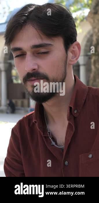 Bearded muslim man sitting in front of mosque showing green screen from ...