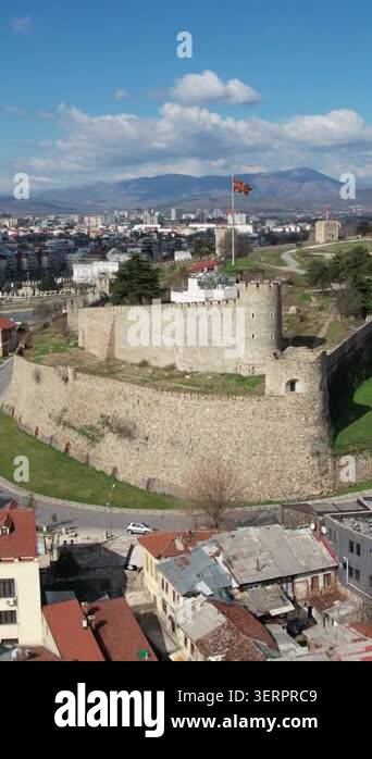 The castle in the center of Skopje is among the buildings, flag waving ...