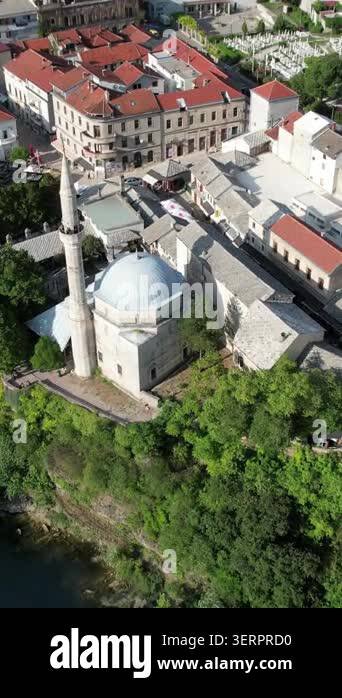 Drone view of the mosque and mostar city built on the side of the ...