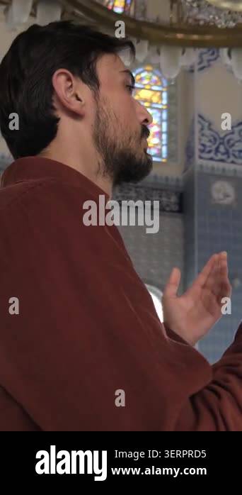 Standing young bearded man praying with open hands, Muslims who go to ...