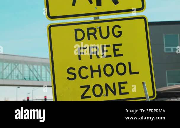 Bright yellow Drug Free School Zone sign with school crossing symbol on ...
