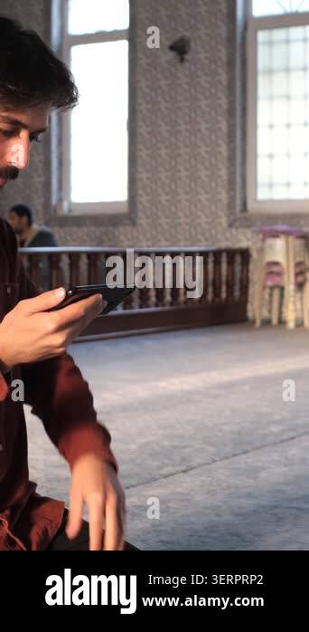 Side view of Muslim bearded man sitting in mosque rubbing chin with ...