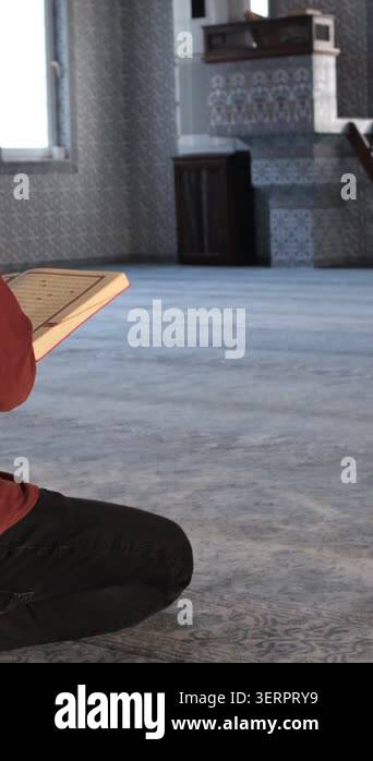 Side views of Muslim men sitting in mosques reading Islamic Quran book ...