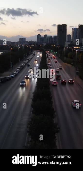 Slowed down view of the traffic of the seaside city at sunset, people ...